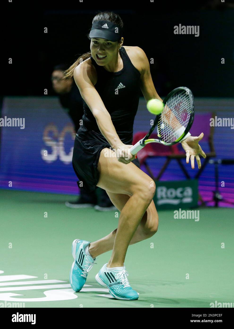 Serbia's Ana Ivanovic makes a backhand return to Romania's Simona Halep ...