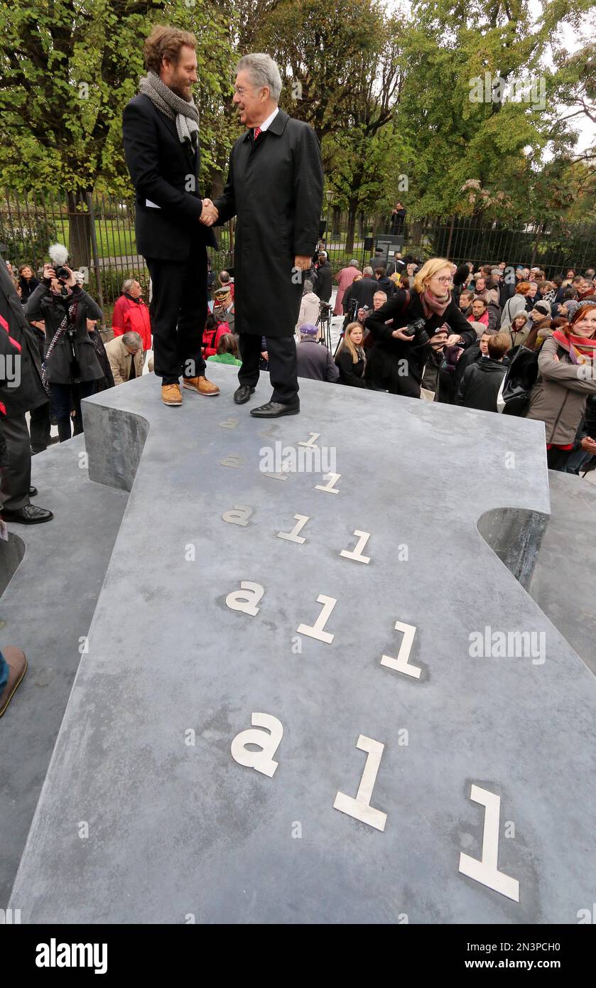 German artist Olaf Nicolai and Austrian President Heinz Fischer, from left, stand on a memorial ...