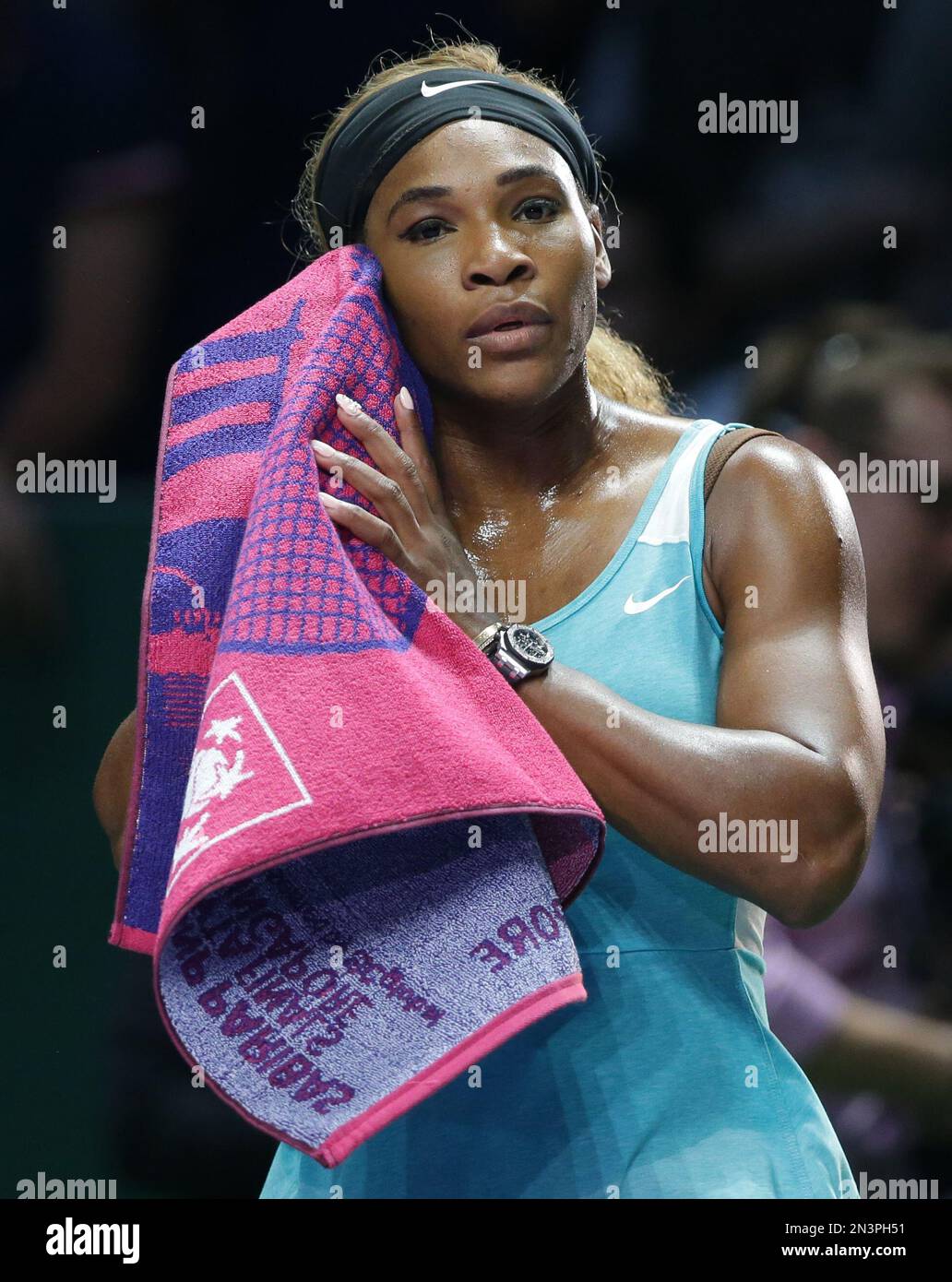 Serena Williams of the US wipes the sweat from her face following her ...