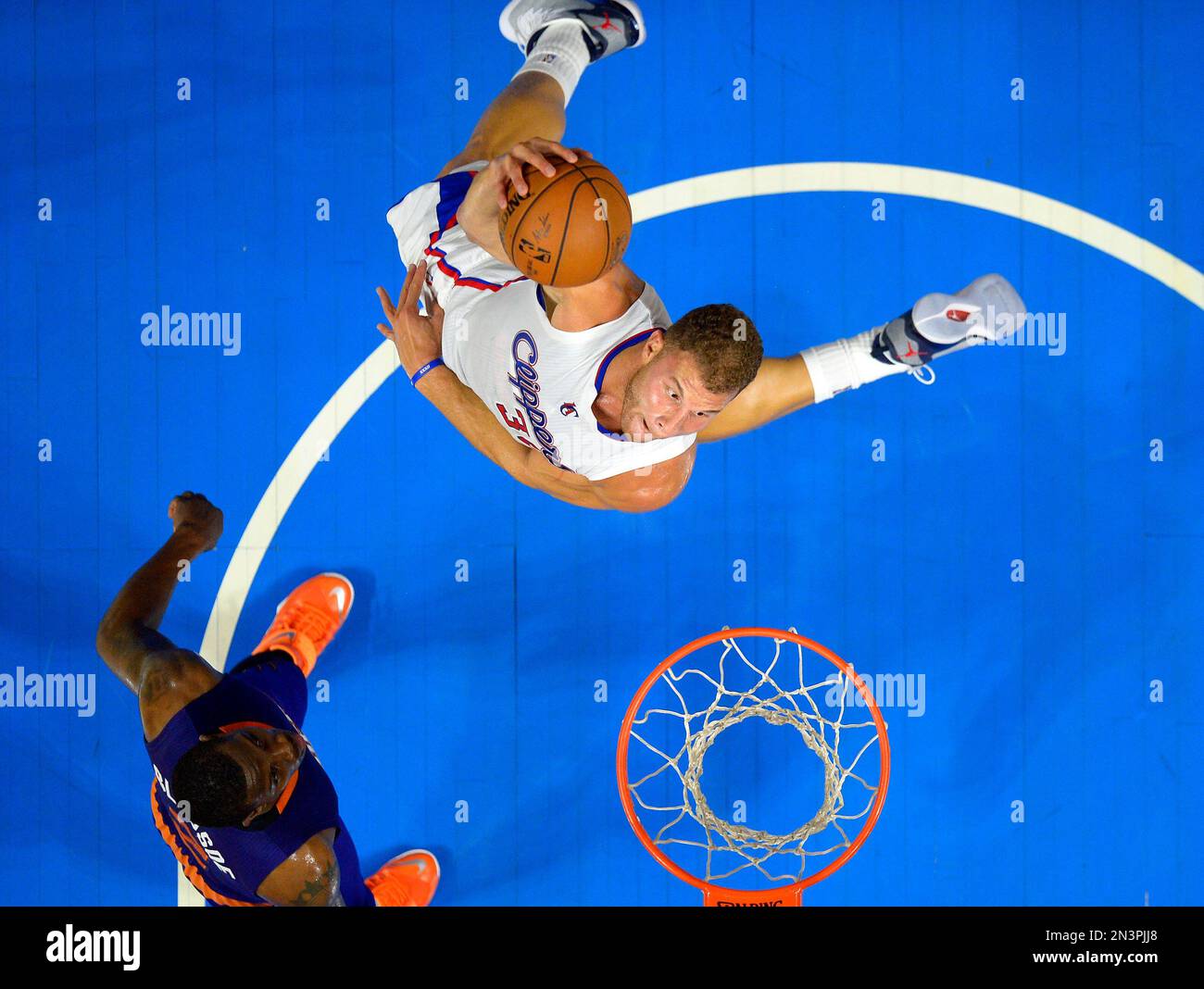 Los Angeles Clippers forward Blake Griffin, top, goes up for a dunk as Phoenix Suns guard Eric ...