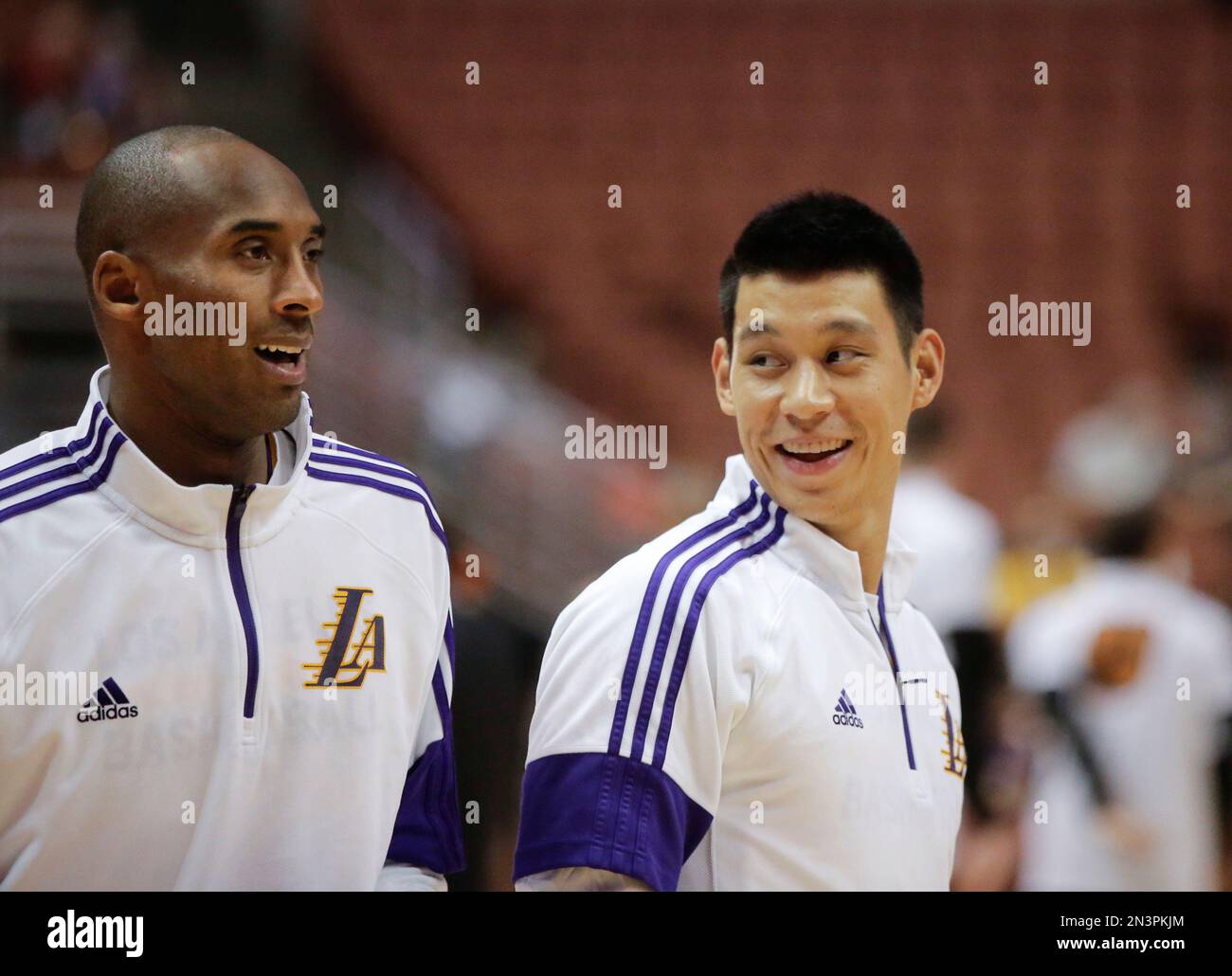 Los Angeles Lakers' Jeremy Lin smiles whilte talking to Kobe Bryant ...