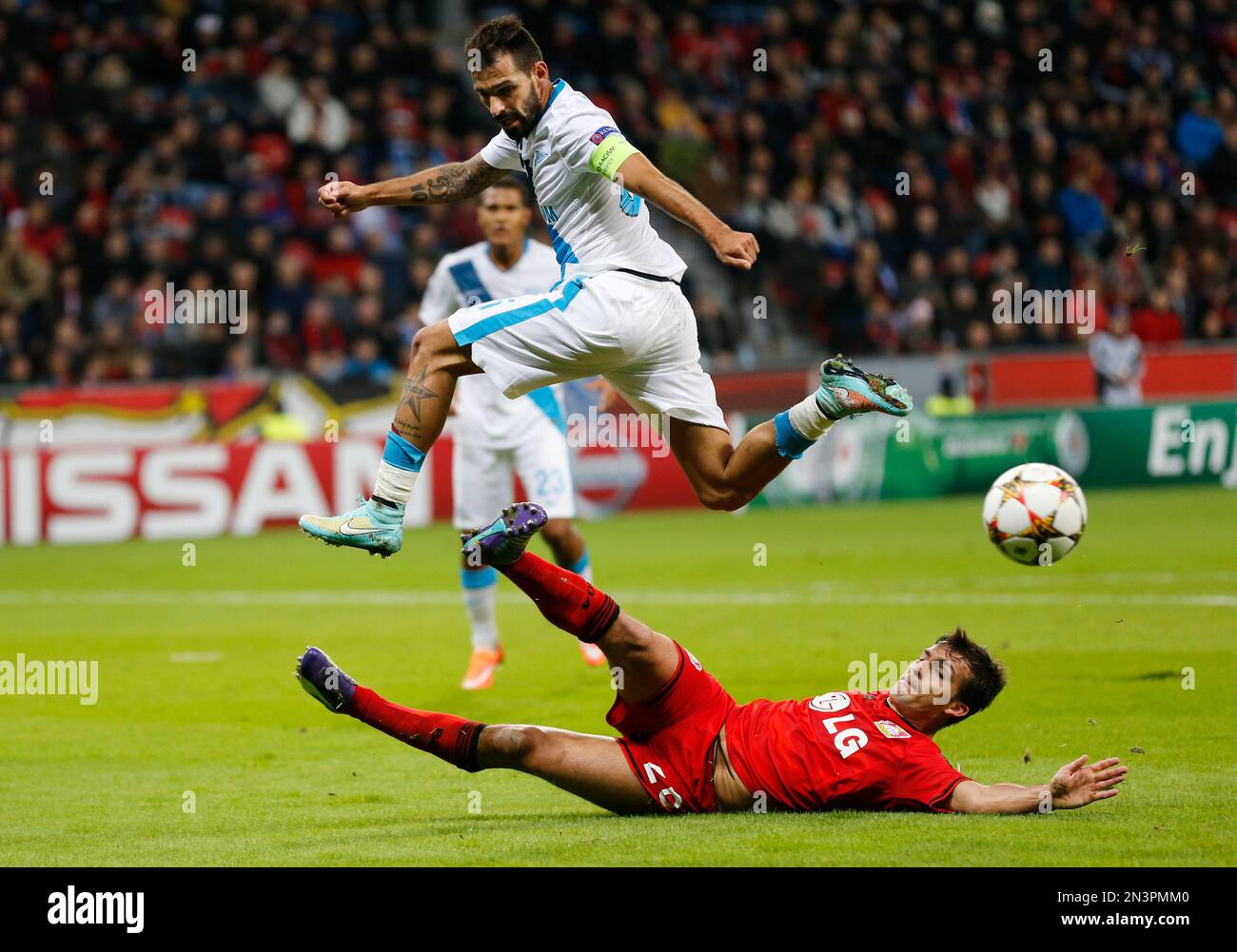 Zenit's Danny jumps over Leverkusen's Giulio Donati, bottom, during the ...