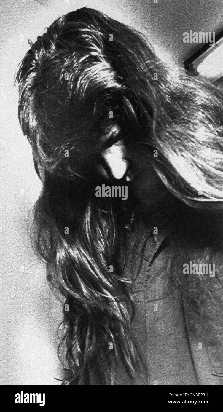 Darci Pierce, 19, tries to shield her face from photographers as she ...