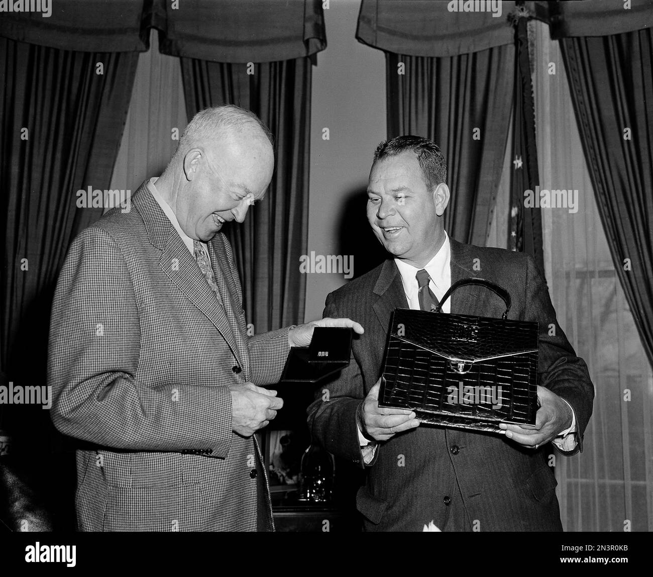 President Dwight D. Eisenhower takes a look at a 1956 American League ...