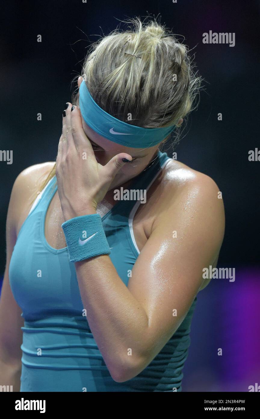 Eugenie Bouchard of Canada wipes sweat from her face as she plays ...
