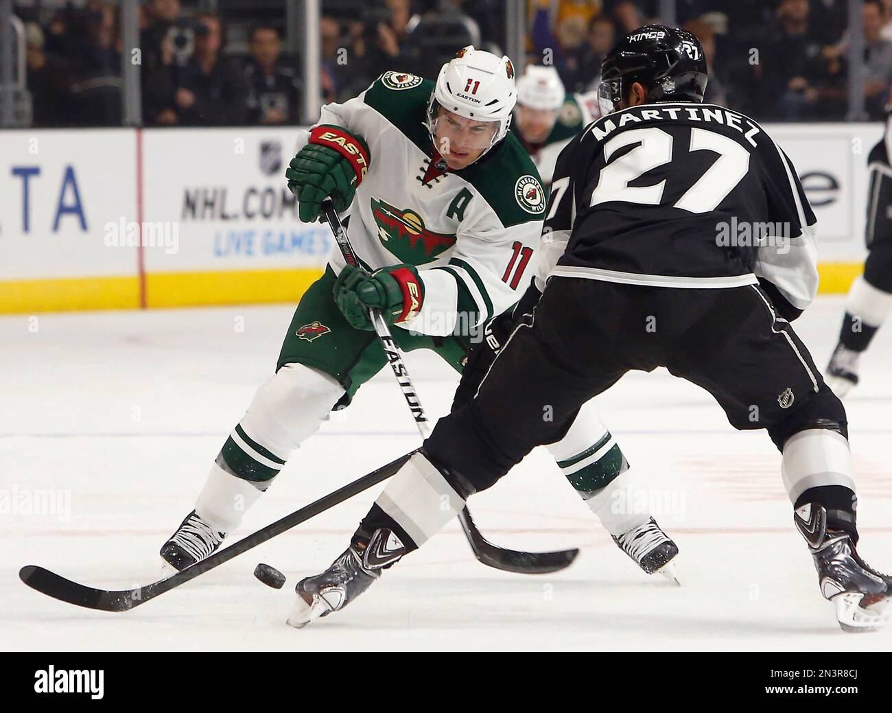 Minnesota Wild left wing Zach Parise (11) passes the puck past Los ...