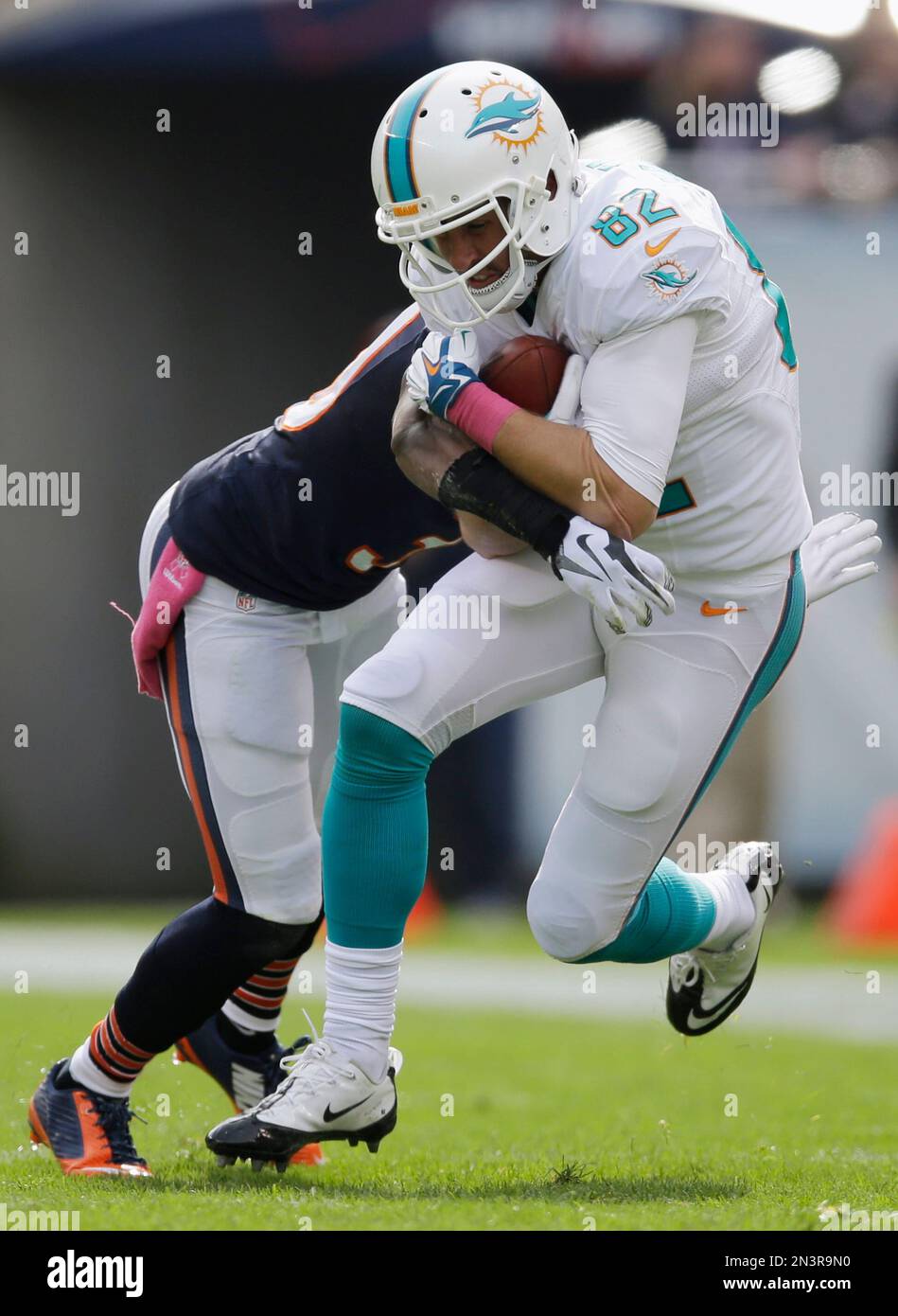Miami Dolphins receiver Brian Hartline (82) gets tackled by Chicago ...