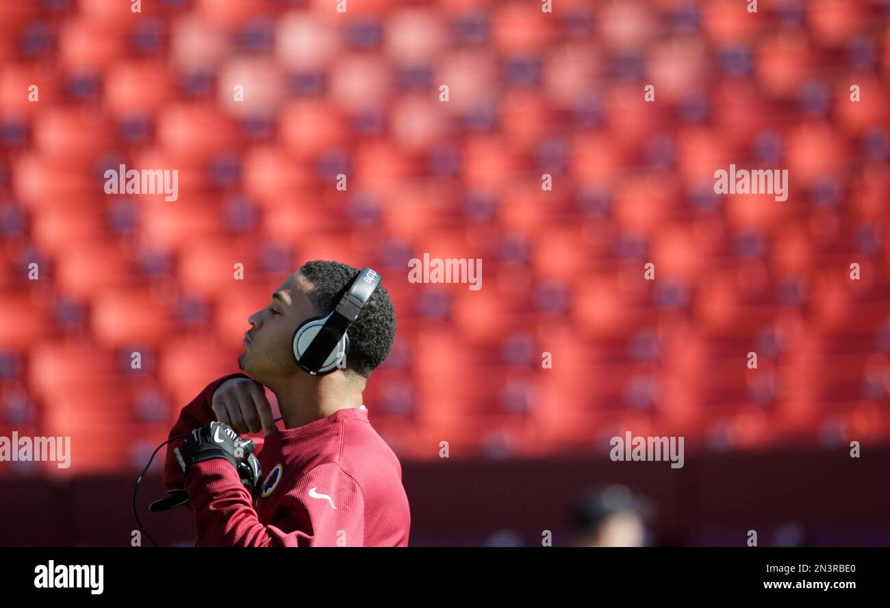 Washington Redskins defensive back Greg Ducre puts tape over the logo ...