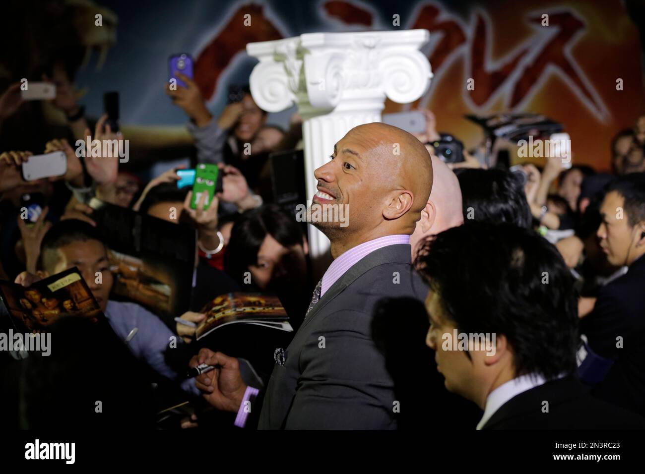 American actor Dwayne Johnson smiles to his fans as he arrives at the ...