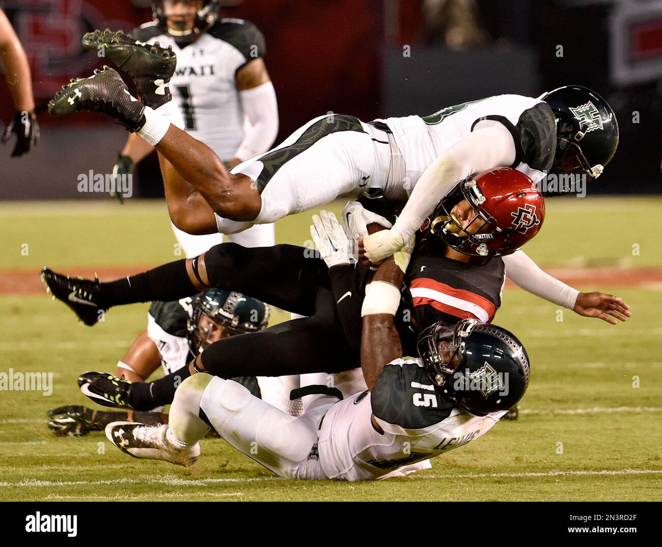 Hawaii defensive back Taz Stevenson (33), top, and defensive back ...