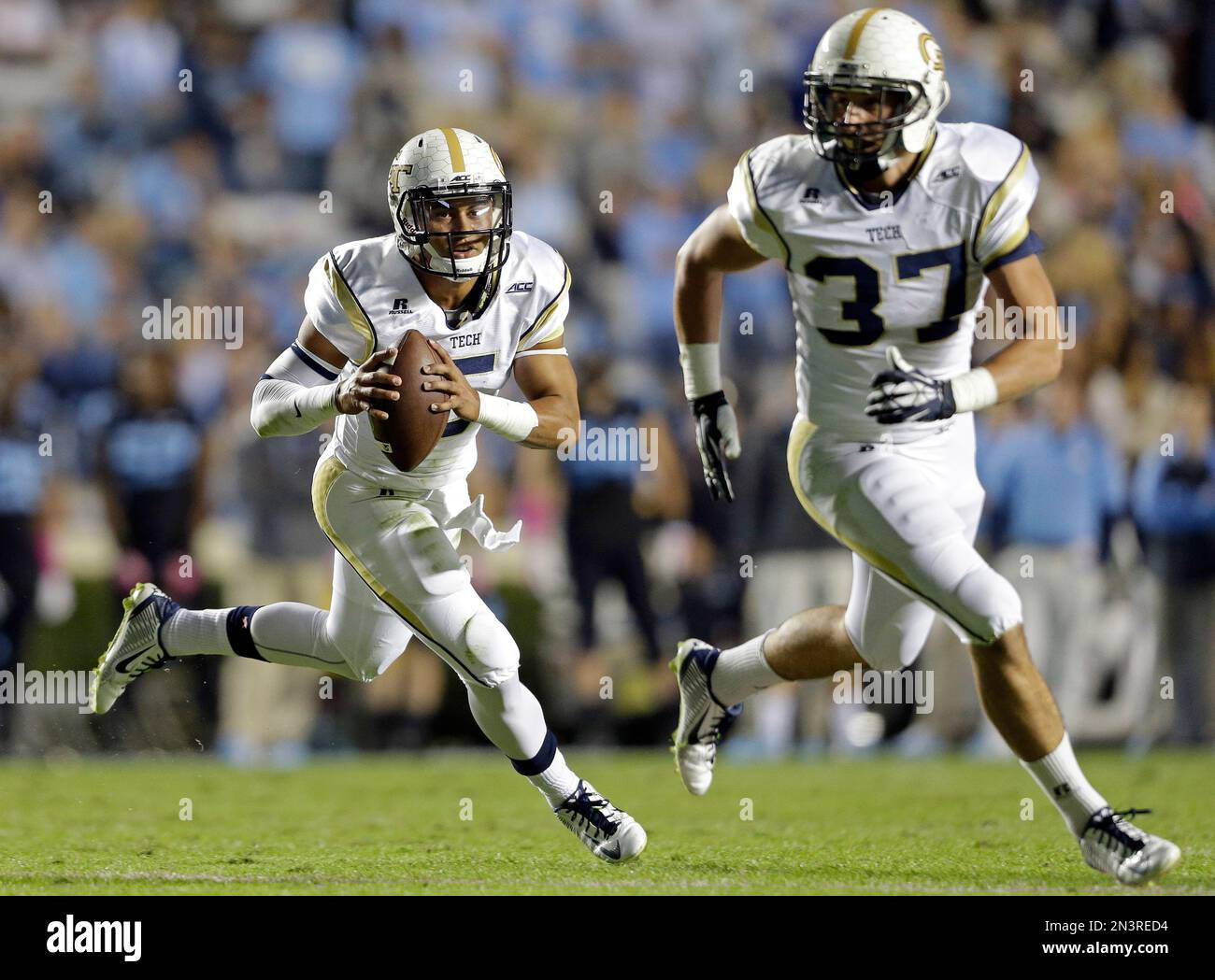 Georgia Tech quarterback Justin Thomas (5) rolls out as Zach Laskey (37 ...