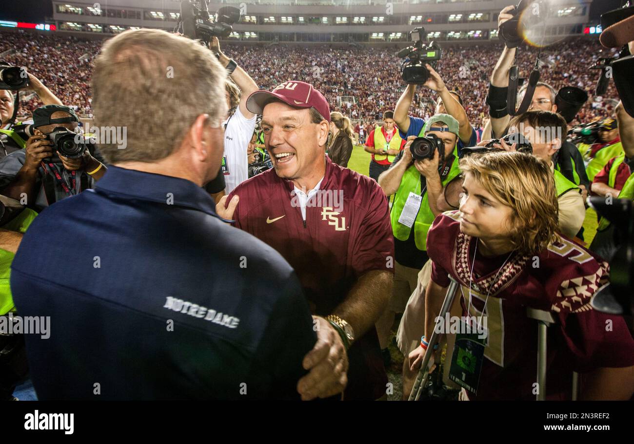 Florida State coach Jimbo Fisher, center, greets Notre Dame coach Brian ...