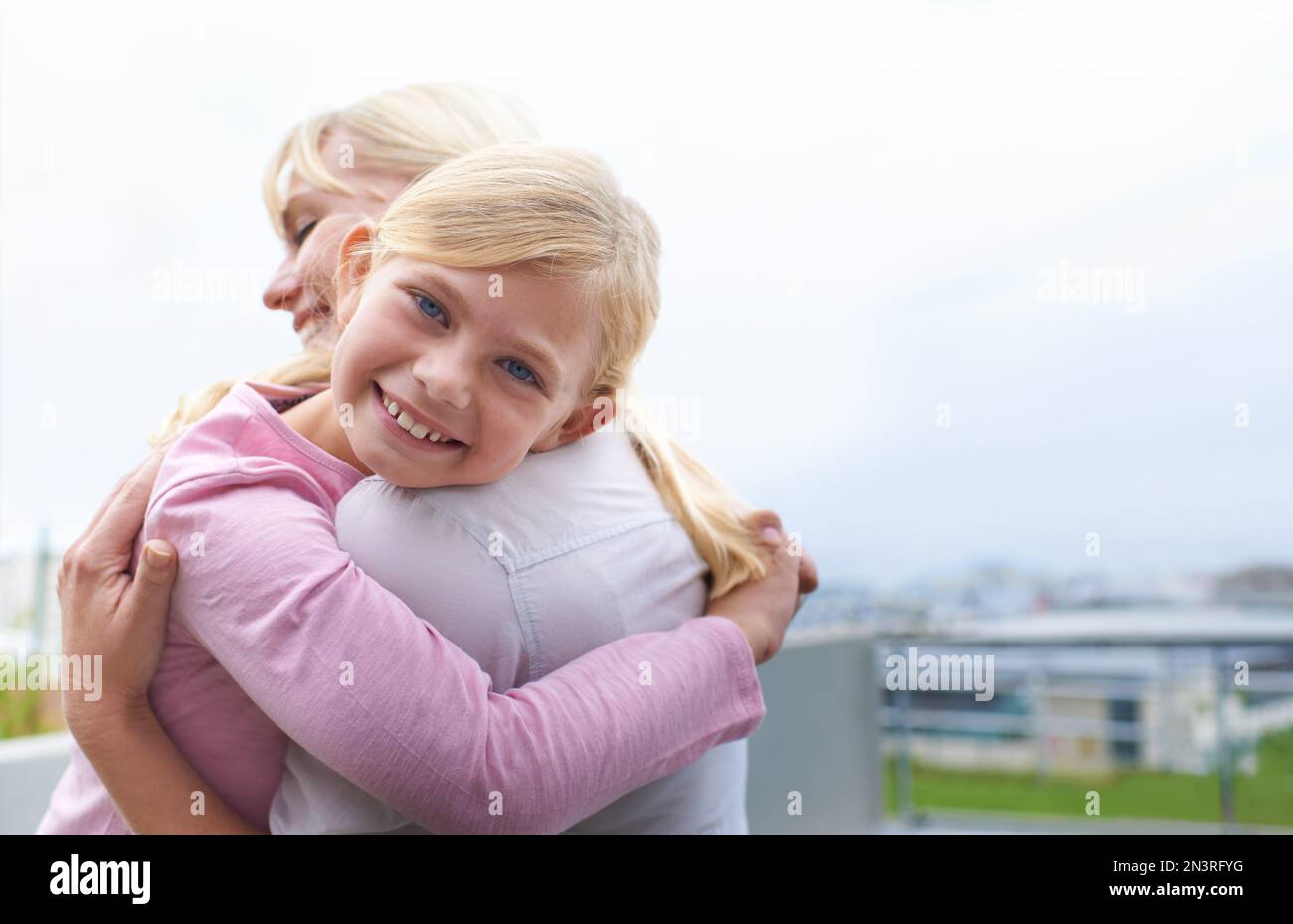 Theres nothing like a mothers love. A happy young girl giving her ...