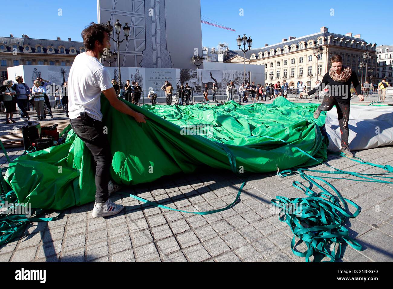 Workers remove the deflated controversial statue "Tree" by U.S. artist ...