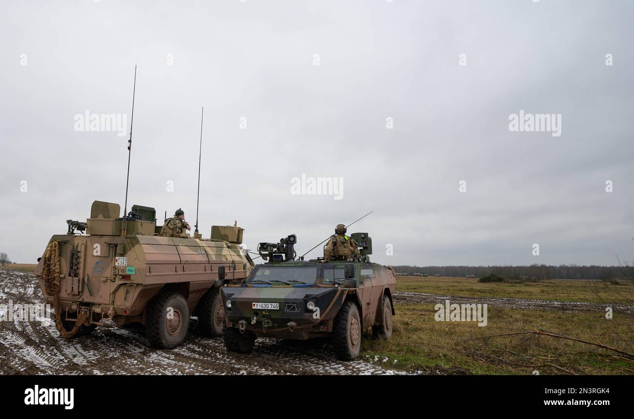 Gardelegen, Germany. 24th Jan, 2023. A Bundeswehr Fuchs armored transport vehicle (l) and a ...