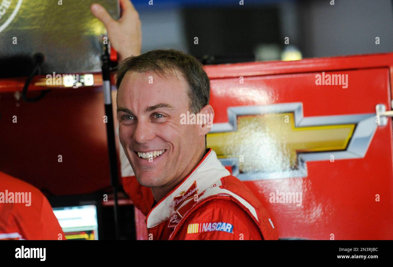 NASCAR driver Kevin Harvick looks on as his car is worked on during ...