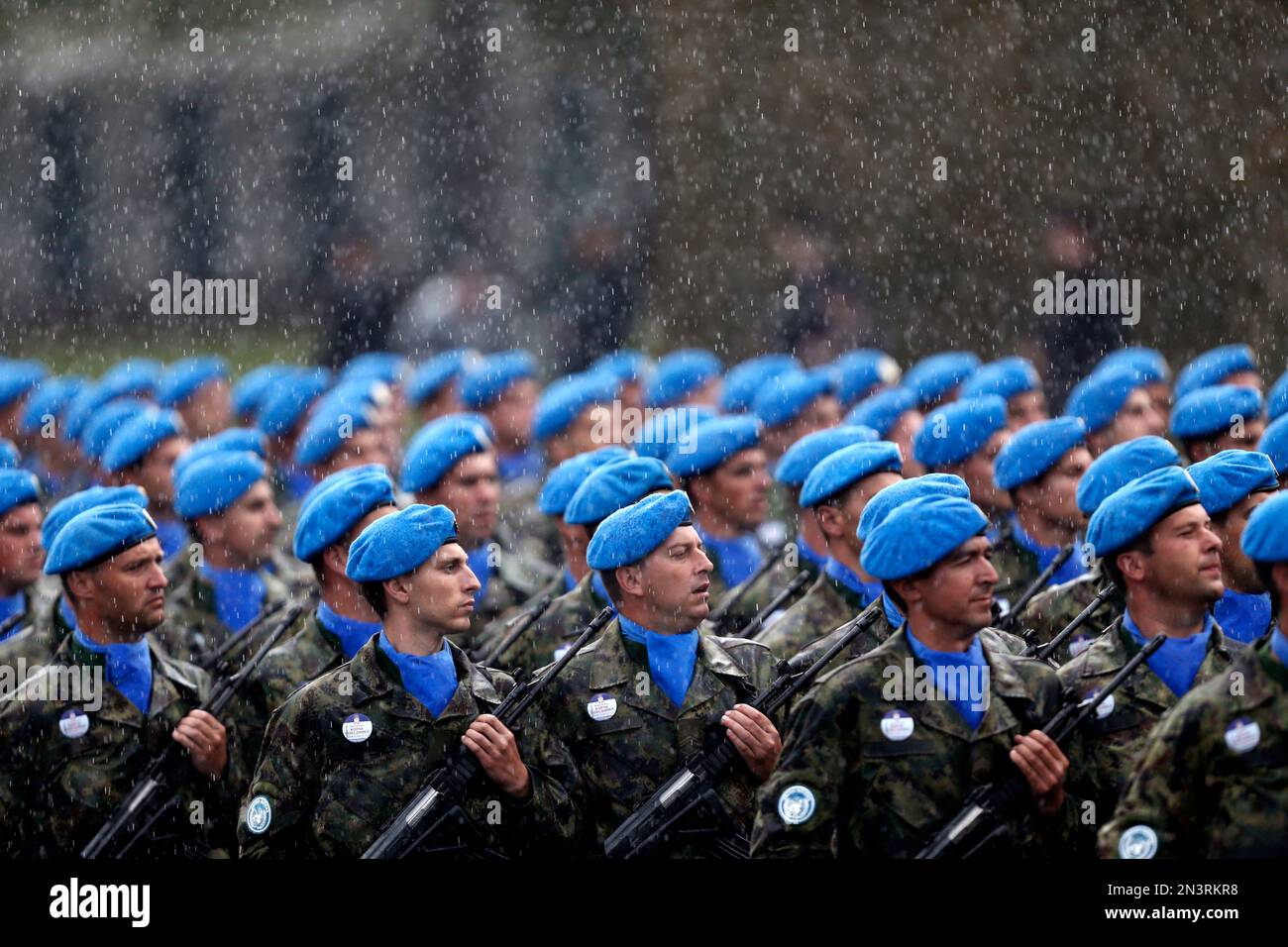 Members of the Serbian army march under heavy rain during a military ...
