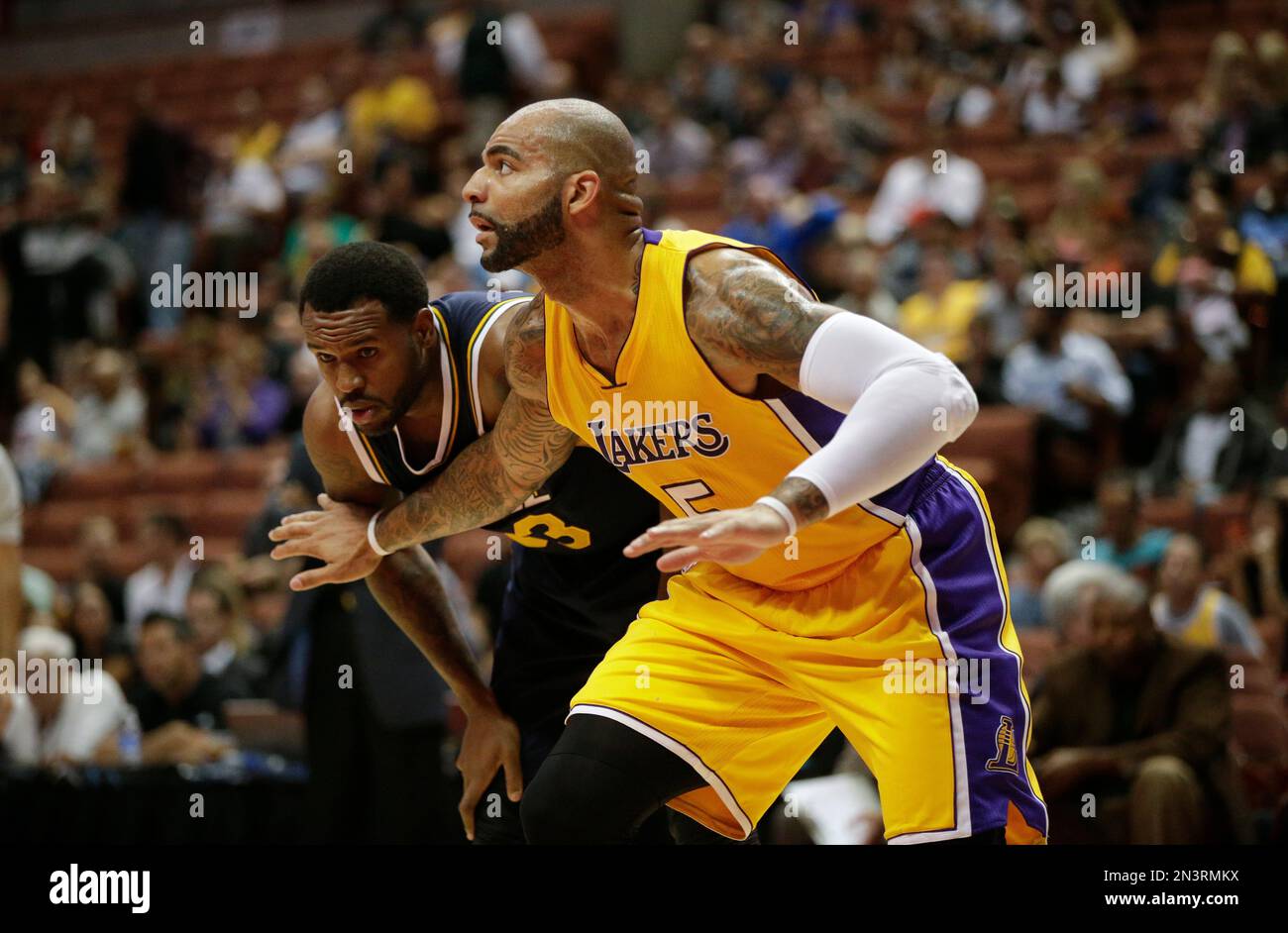 Los Angeles Lakers' Carlos Boozer, right, and Utah Jazz's Trevor Booker ...