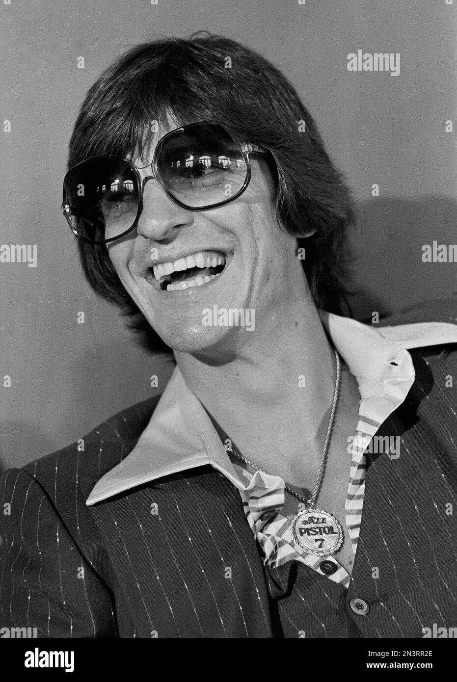 New Orleans Jazz basketball star Pete Maravich smiles during a press ...