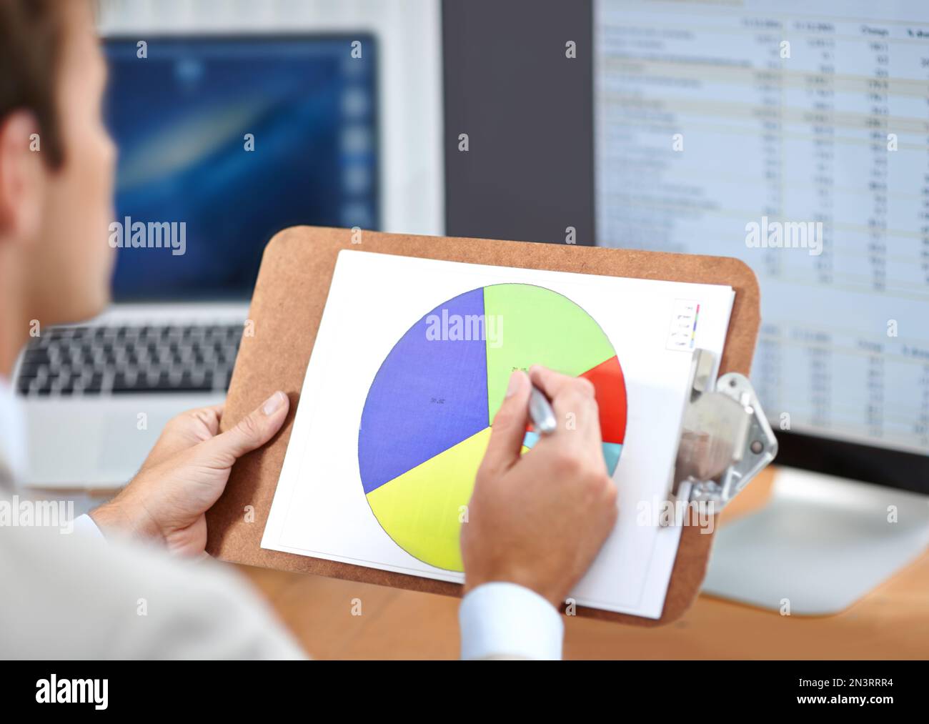 Gaining insight through graphs. Over the shoulder shot of a businessman ...