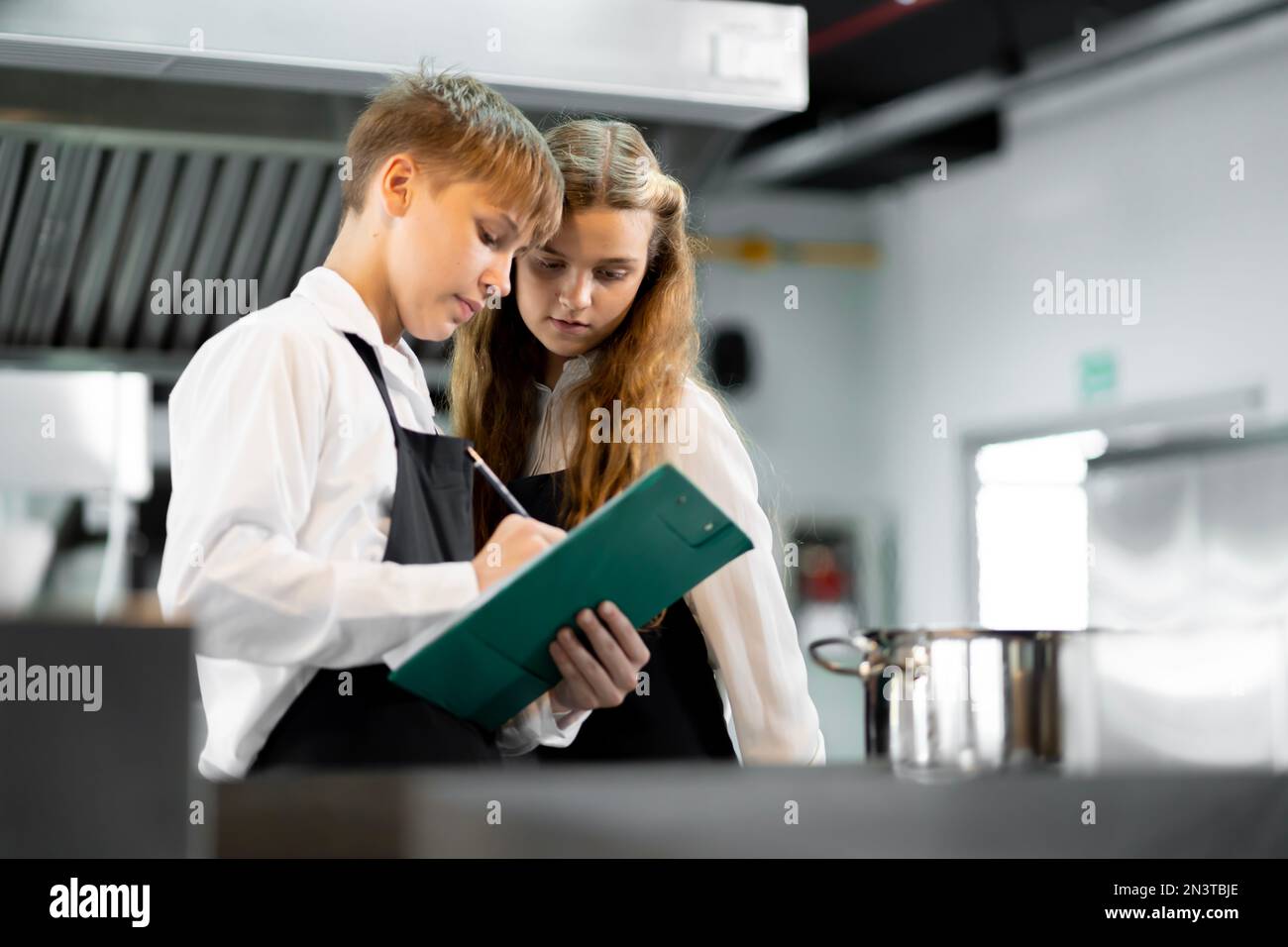Students are learning to cook in a culinary institute with a standard ...