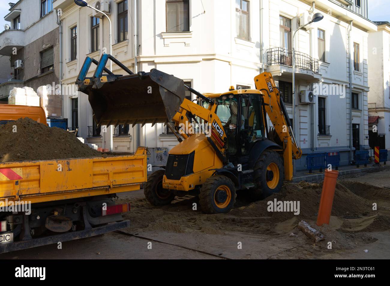 Construction workers at construction site and heavy duty bulldozer in ...
