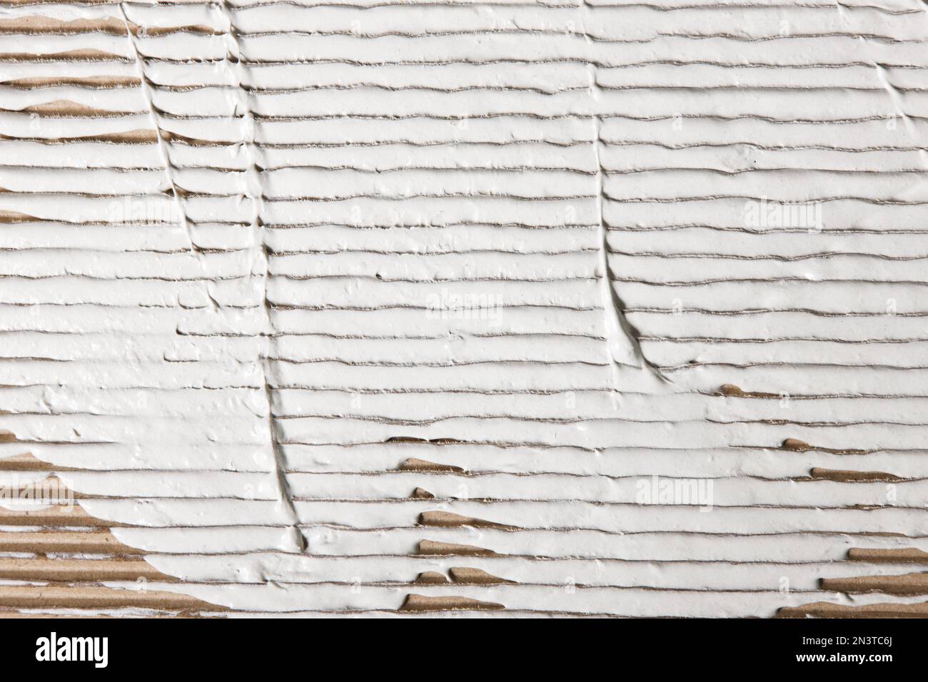 Closeup of white plaster smeared on cardboard Stock Photo - Alamy