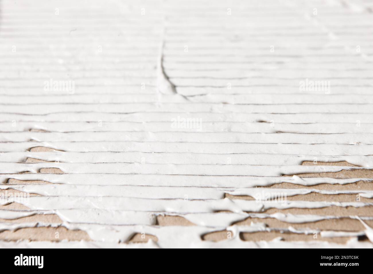 White wet plaster spread on corrugated cardboard Stock Photo - Alamy