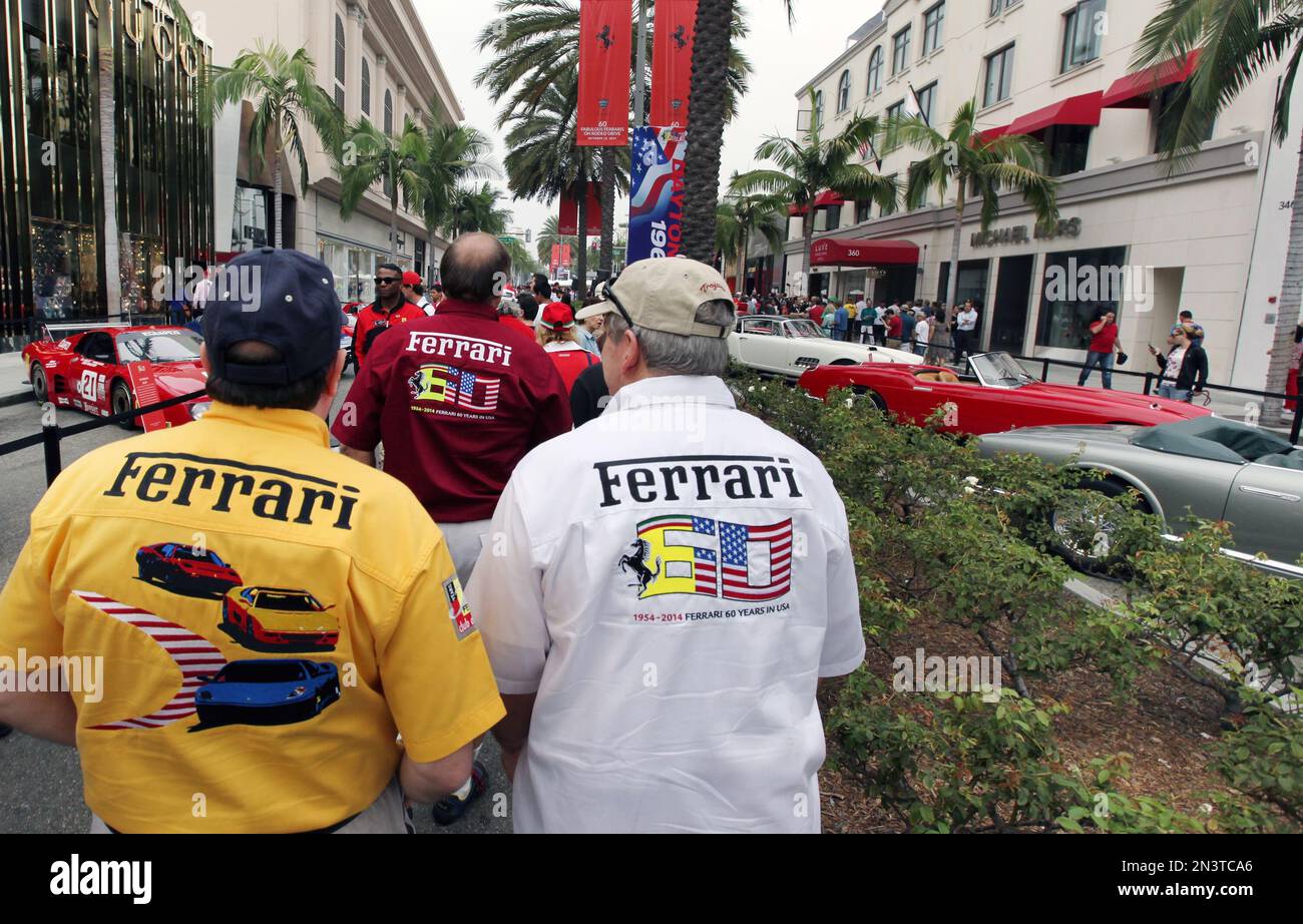 Ferrari enthusiasts walk along Rodeo Drive lined Ferraris in Beverly ...