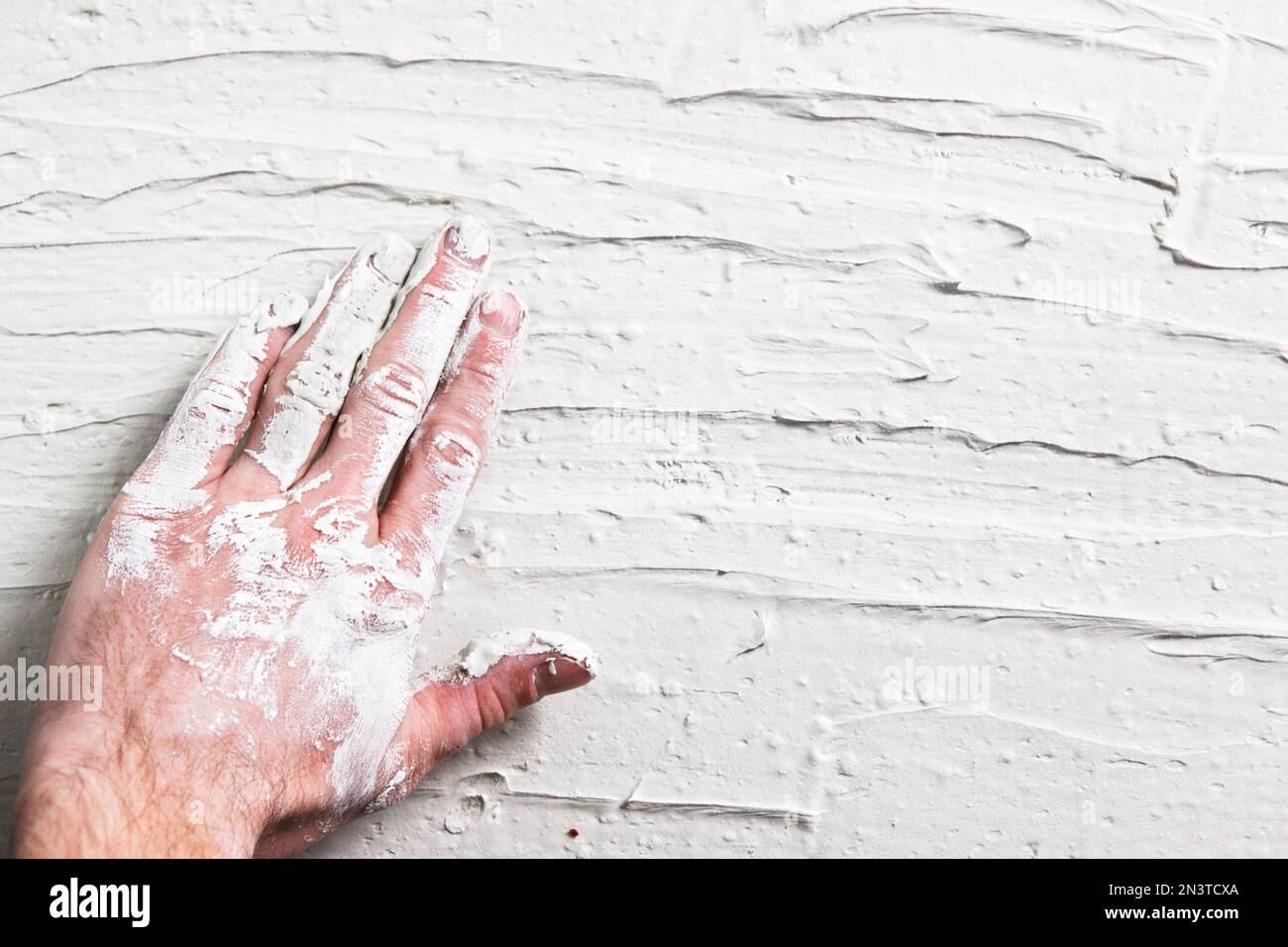 Repair background. Plaster wall with worker hand Stock Photo - Alamy