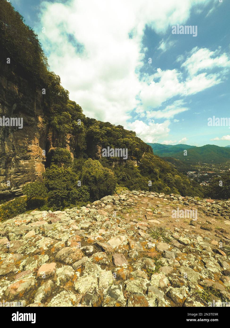 A vertical shot of rocky mountains covered with greenery in Malinalco ...