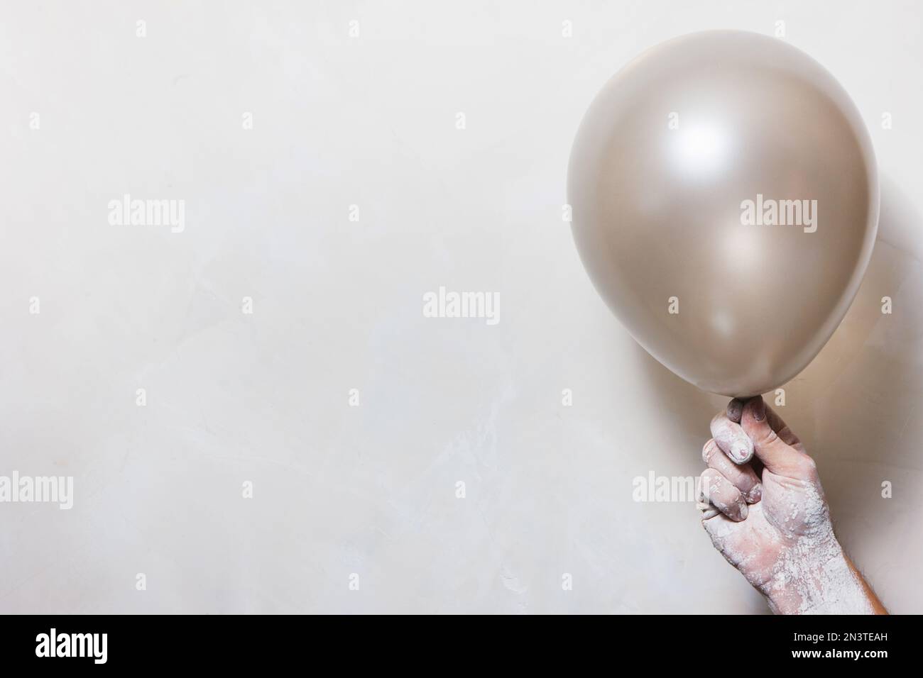 Hand in plaster with balloon on white background Stock Photo - Alamy