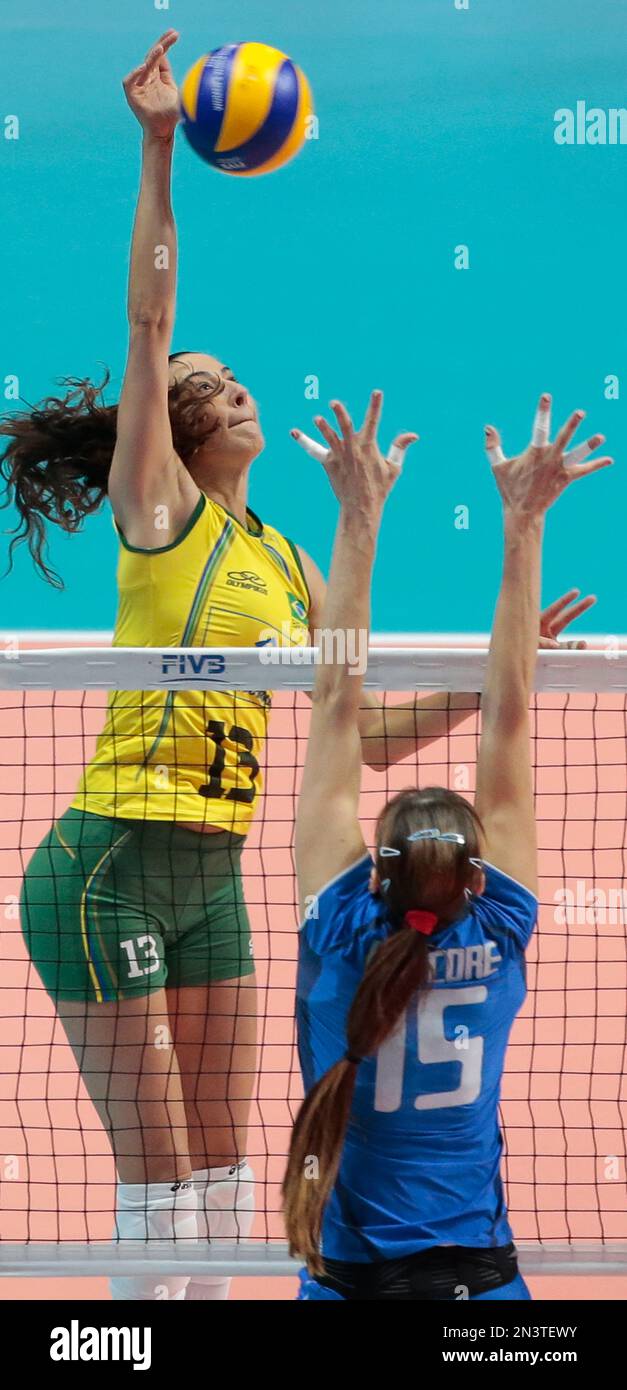 Brazil's Sheilla Castro De Paula Blassioli, left, spikes the ball ...