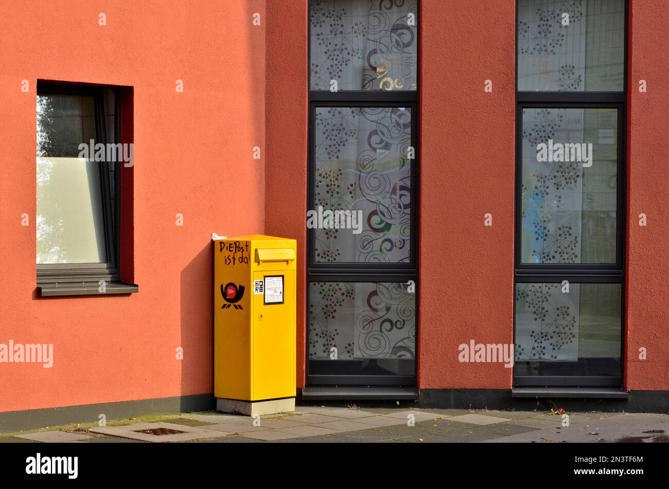 Yellow public letterbox of Deutsche Post Stock Photo - Alamy