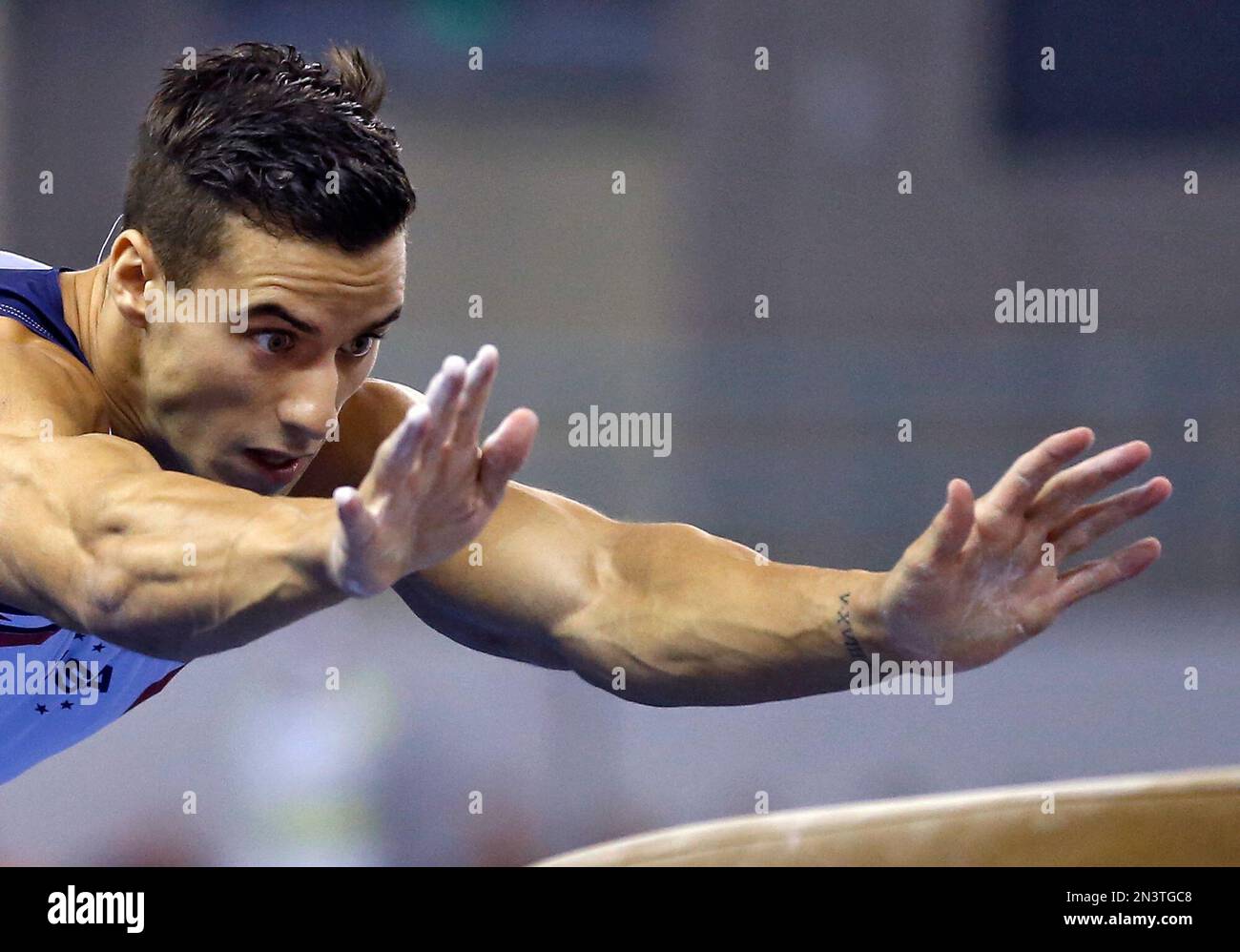 Jacob Dalton of the United States jumps onto the vault as he competes ...