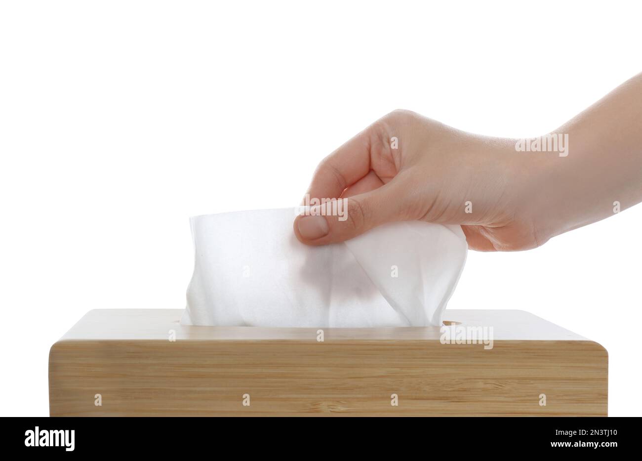 Woman taking paper tissue from holder on white background, closeup ...