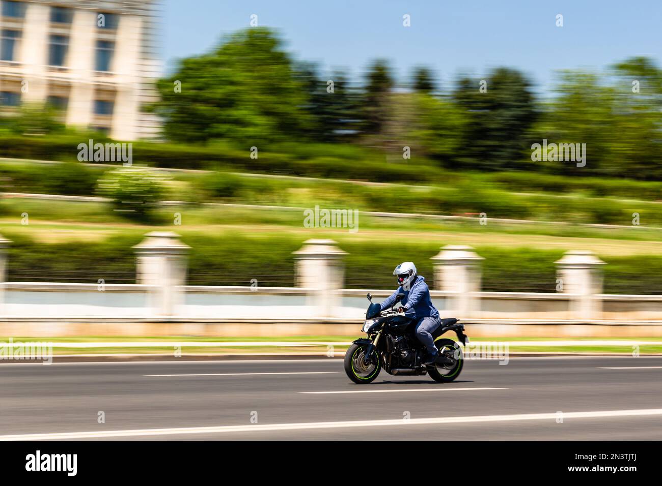 Biker on a motorcycle in traffic at rush hour in downtown area of the ...