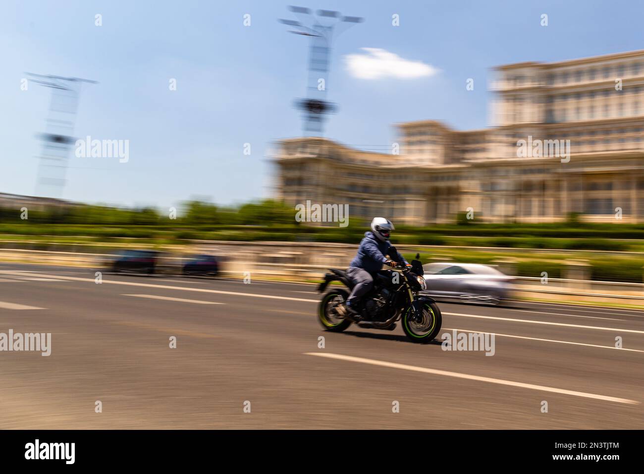 Biker on a motorcycle in traffic at rush hour in downtown area of the ...