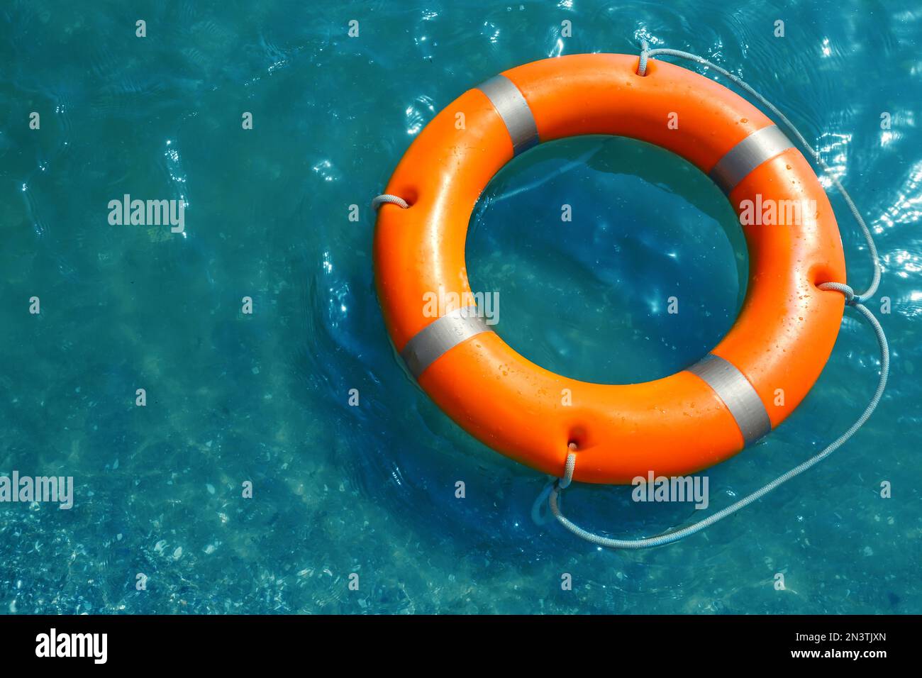 Orange life buoy floating in sea, above view. Emergency rescue ...