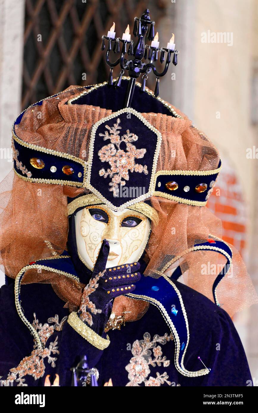Costumed woman with traditional Venetian mask, carnival in Venice ...