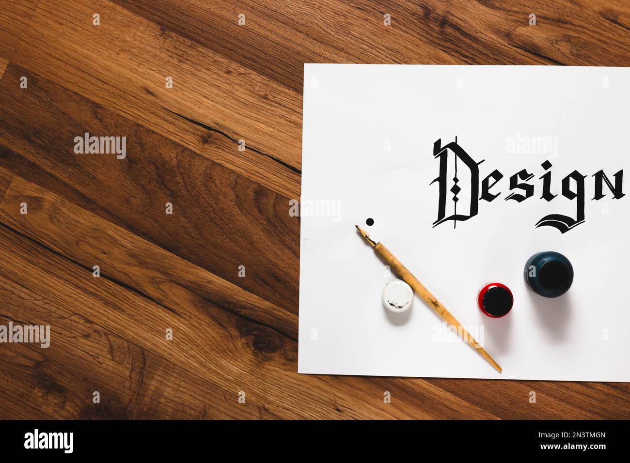 Ink calligraphy design wooden background Stock Photo - Alamy