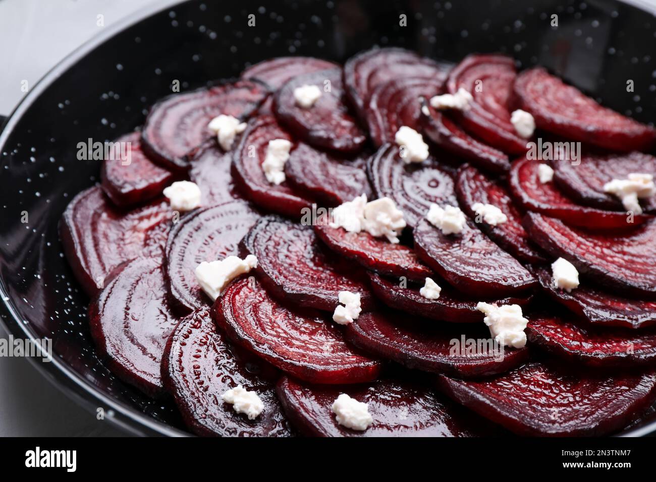Roasted beetroot slices with feta cheese in wok pan, closeup Stock ...