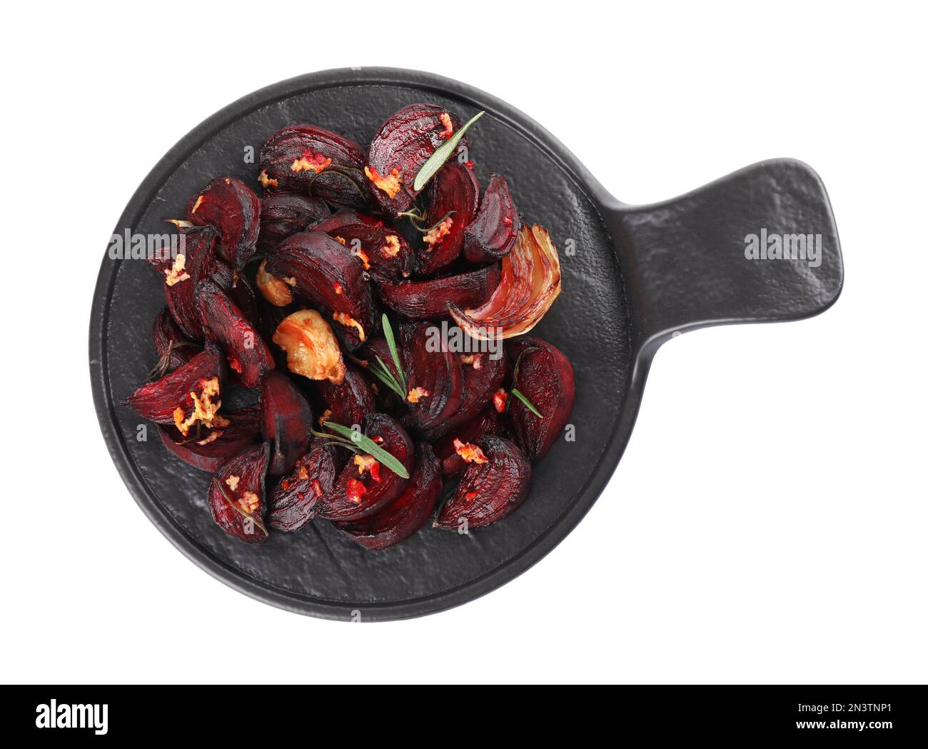 Slate plate with roasted beetroot slices, garlic and rosemary isolated ...