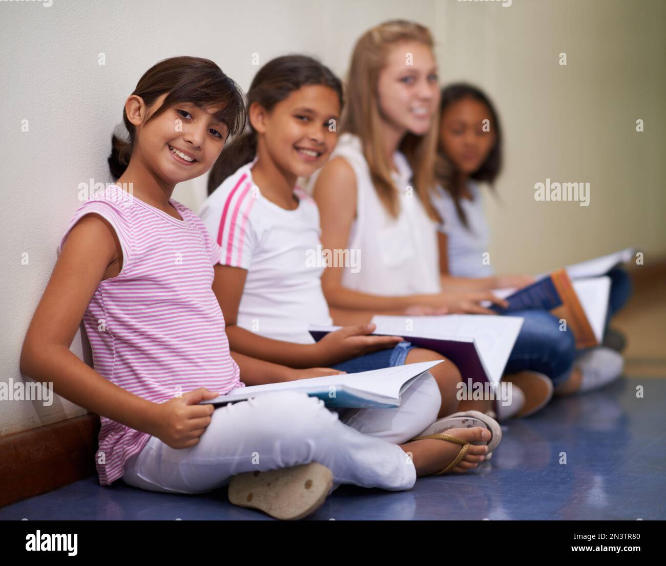 Eager young minds. Portrait of a young female students reading while ...
