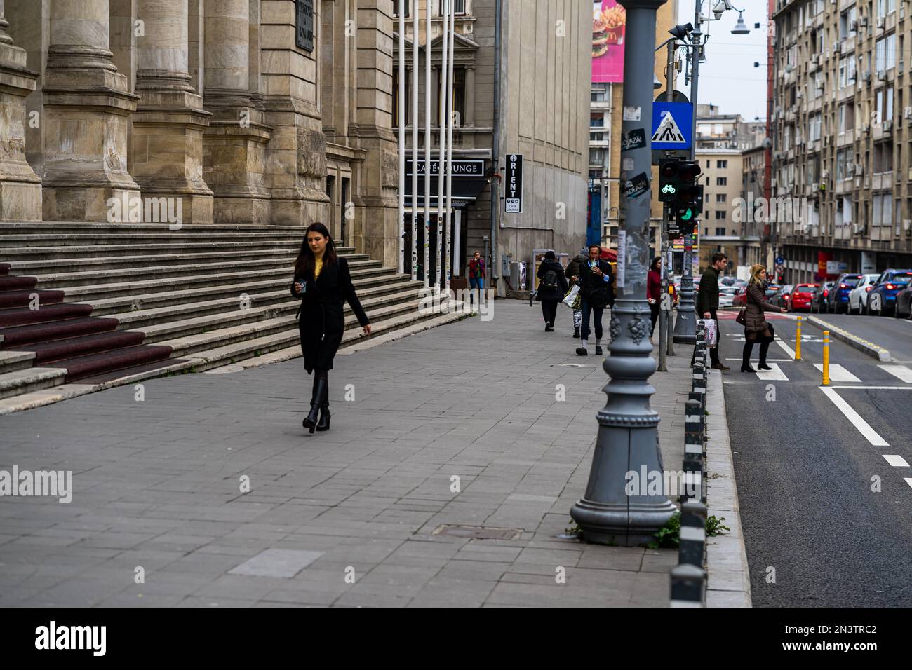 People and tourists wander the streets of the Bucharest Old Town ...