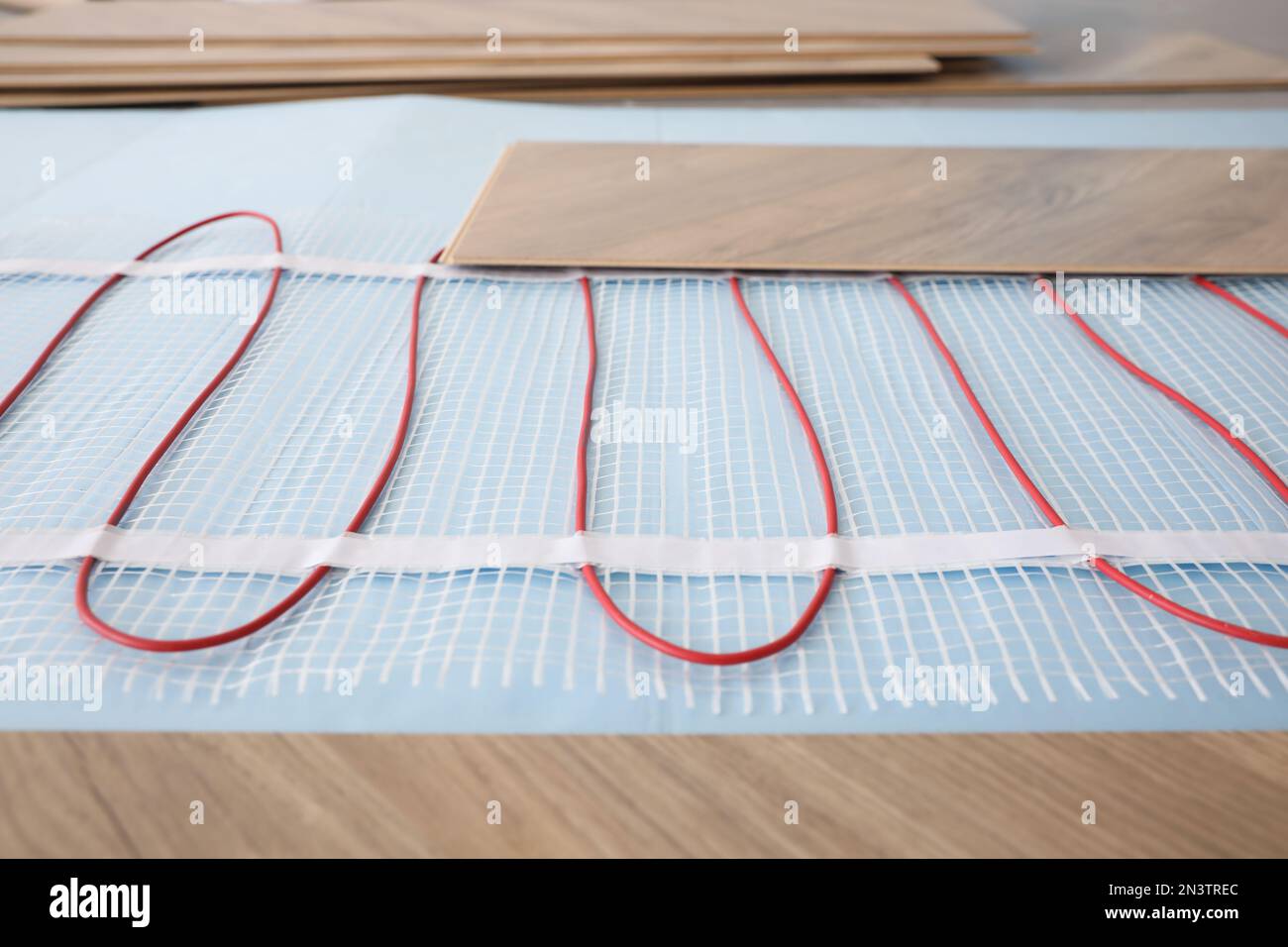 Installation of modern underfloor trace heating system indoors, closeup ...