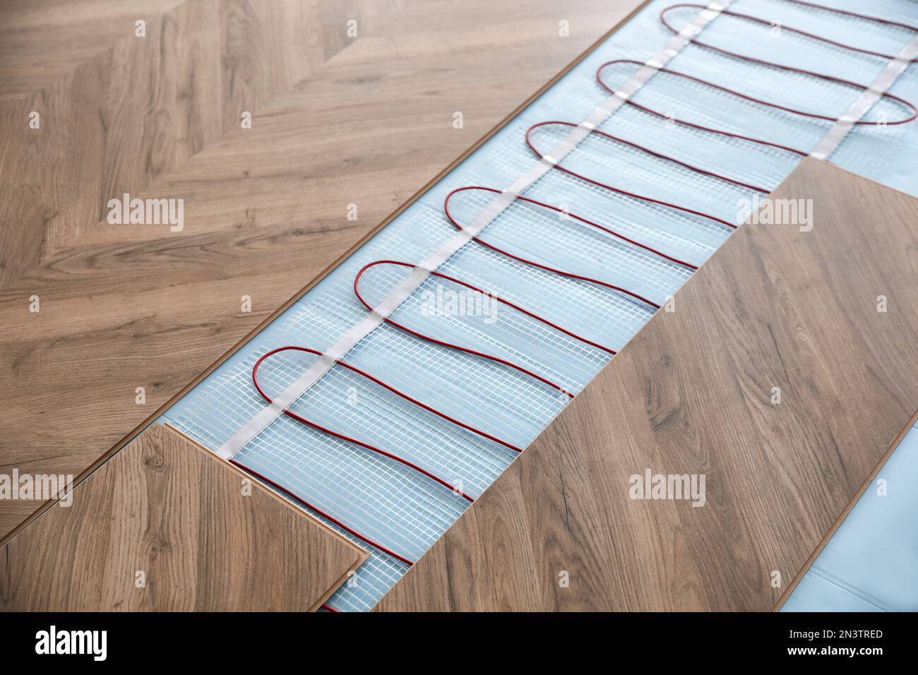 Installation of modern underfloor trace heating system indoors Stock ...