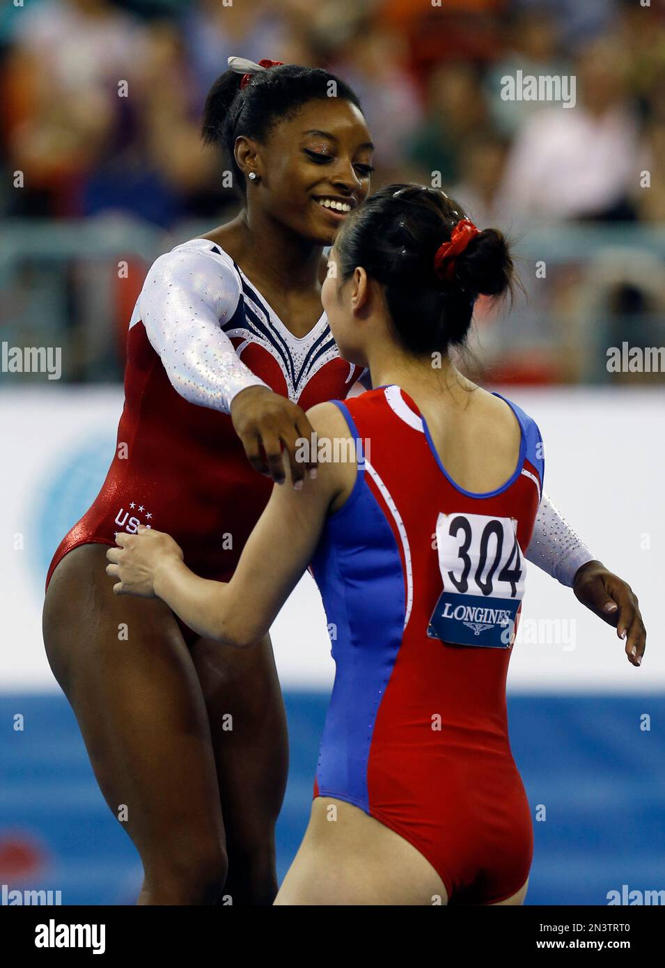 Gold medalist Hong Un Jong of North Korea, right, hugs second place ...