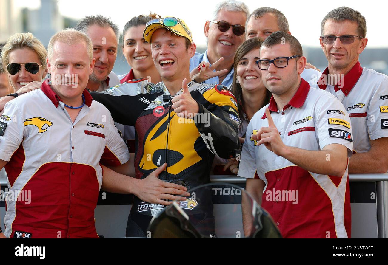 Moto2 rider Esteve Rabat, center, of Spain and team members pose for ...