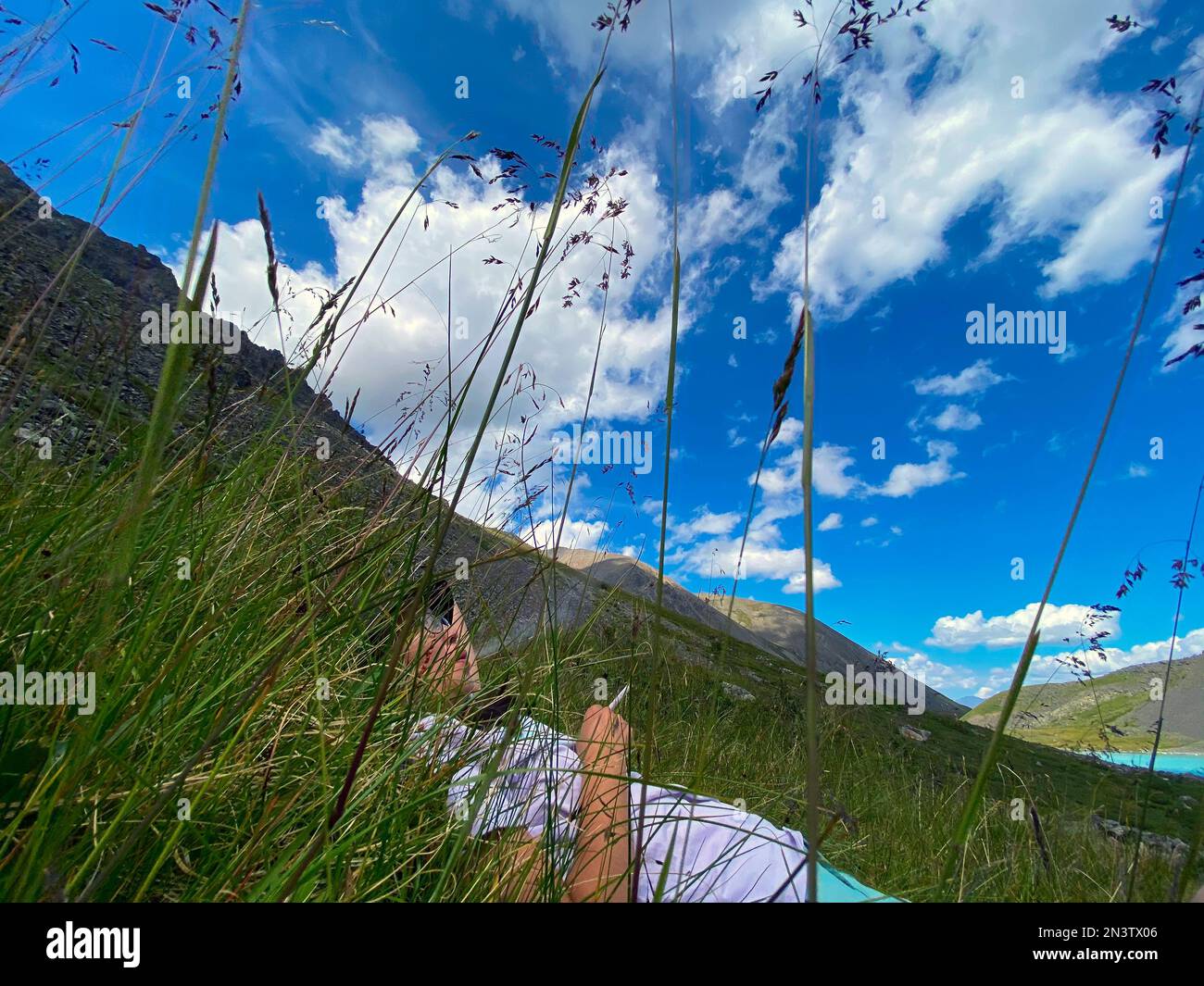 An Asian girl in a hat and glasses smokes a cigarette lying in the ...